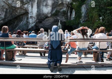 Lourdes, France - Praying before the Virgin Crowned statue Stock Photo ...