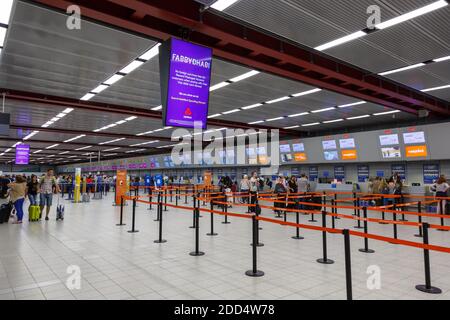 London Luton Airport, UK, check-in hall. Easyjet passengers queue to ...