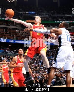 Houston Rockets' Chase Budinger (10) jumps over singer P. Diddy during ...