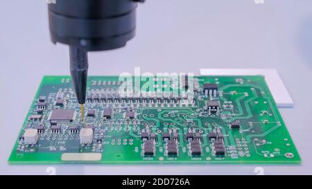 Automatic manipulator with dispenser needle during work with SMT pcb ...