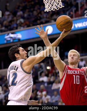 Houston Rockets' Chase Budinger (10) jumps over singer P. Diddy during ...