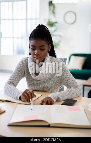 Young african american woman doing rehab using dumbbells at clinic ...