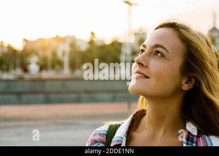 Beautiful blond woman looking up Stock Photo - Alamy