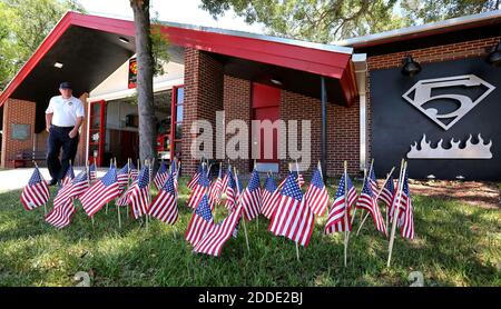 Flags in honor of fire victims are placed on a table on the one-year ...