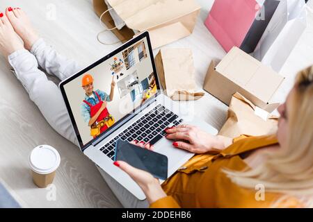 young manual worker displaying laptop over white background Stock Photo ...
