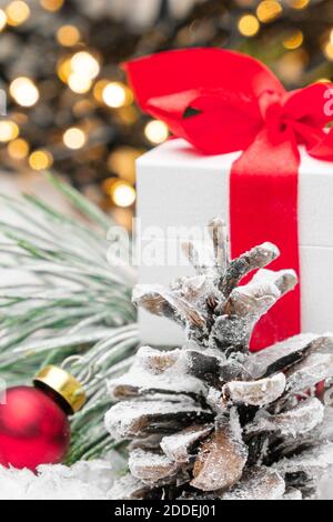 Christmas gift box under pine trees, on wooden table on background of ...