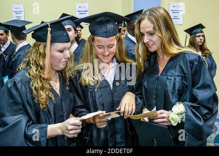 Graduation cap and diploma taking center stage in blue background Stock ...