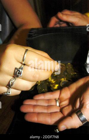 Cash transaction hand with coins Stock Photo - Alamy