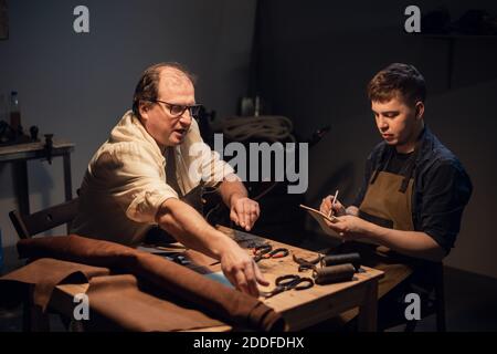 a father-shoemaker passes on to his son the experience of hand-making ...