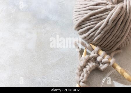 Female hands knitting with gray wool. Close up of knitting wooden ...