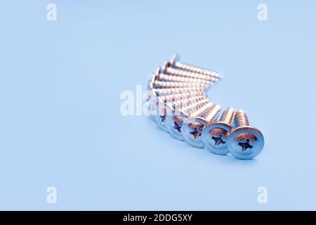 screws a lot, macro photo. Long Iron or metal screw nails on red ...