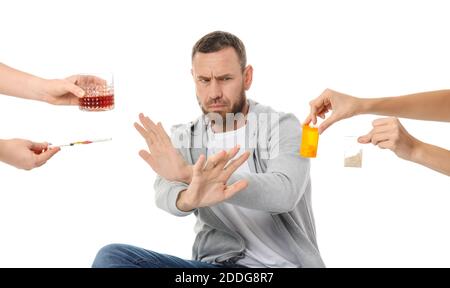 Male junkie with drugs and alcohol on white background. Concept of ...