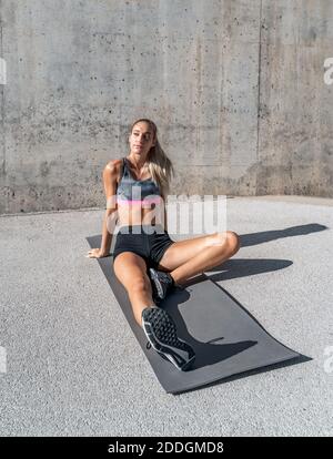 Woman athlete resting after training with dumbbells. Copy space ...