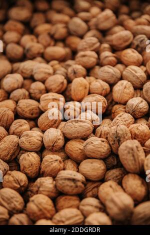 Walnut background, scattered pile of walnuts Stock Photo - Alamy