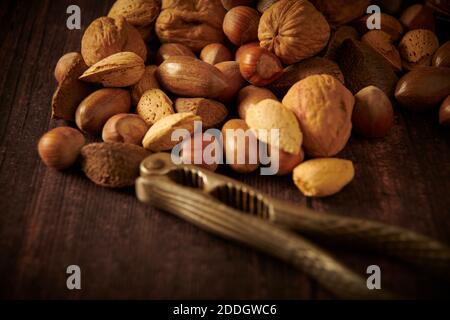 Mixed nuts in their shells with vintage nut crackers , England, Uk, Gb ...