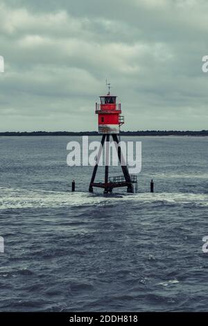 A view of a watchtower at the sea under the cloudy sky in Borkum ...