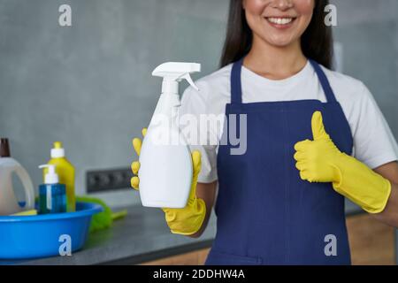 cropped shot of cleaner with detergent showing thumb up isolated on ...