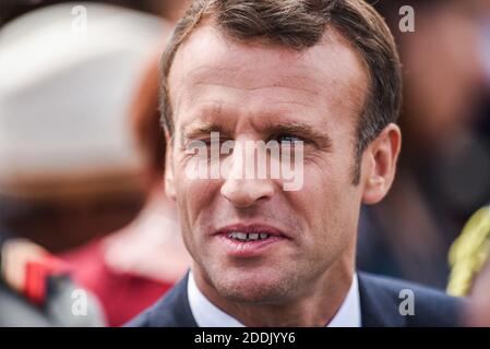 French President Emmanuel Macron blinks as he poses with and EU ...