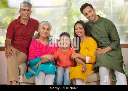 Portrait of a joint family in the living room Stock Photo - Alamy