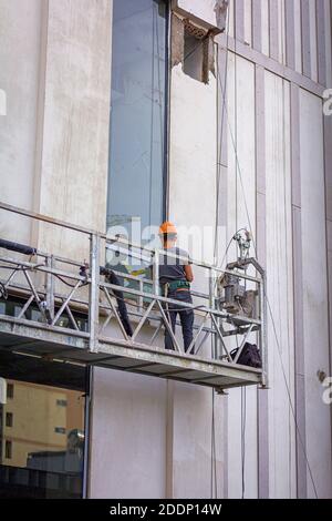 Construction site workers are doing ceiling soffit skim coat work at ...