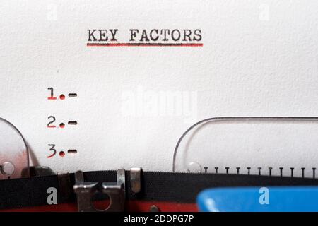 Key factors phrase written with a typewriter Stock Photo - Alamy