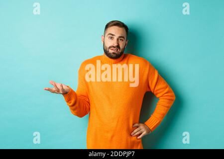 Careless and indifferent guy shrugging, looking unbothered, dont know ...