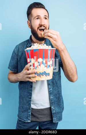 Adult watching comedy movie on tv channel, doing remote freelance job ...