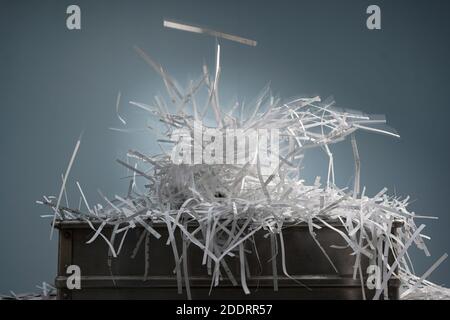Shredded paper stripes seem to explode in a box and expand their volume ...