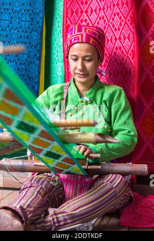 Evelinda Otong Hamja wearing traditional Yakan clothes weaving at the ...