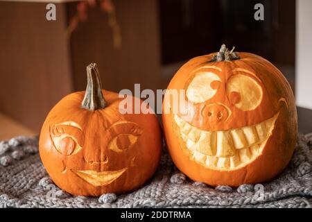 Cute Halloween pumpkins with funny smiling faces and paper bats flying ...