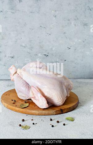 Carcass of the whole chicken ready to preparation on a white background ...