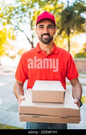 Delivery boy with cardboard pizza box isolated on white Stock Photo - Alamy