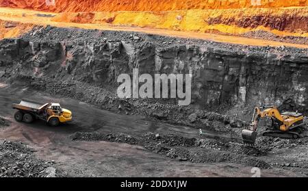 Excavators Working On Huge Mining Site, Loading The Trucks, Trucks ...