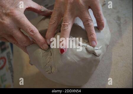 a hand touching a ball of clay, human tactile and haptic perception ...