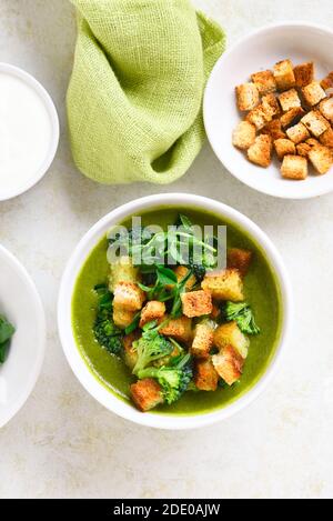 Fresh green pea soup bowl on white tile background Stock Photo - Alamy
