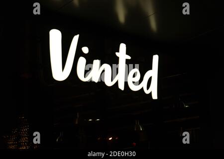 Shiny Vinted logo sign at night. New Vinted office in Vilnius. Vinted ...