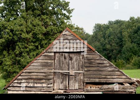 Vintage Wooden Triangle Barn in a Farm with Mountain Background Stock ...