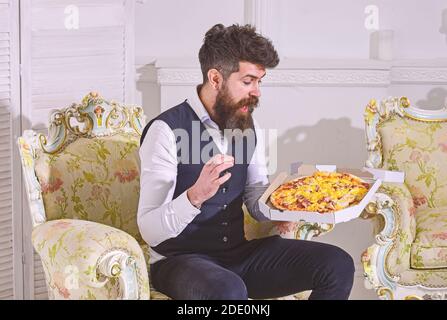 Surprised handsome man with tasty pizza on color background Stock Photo ...