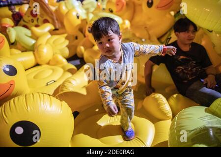 Boy with inflatable duck Stock Photo - Alamy