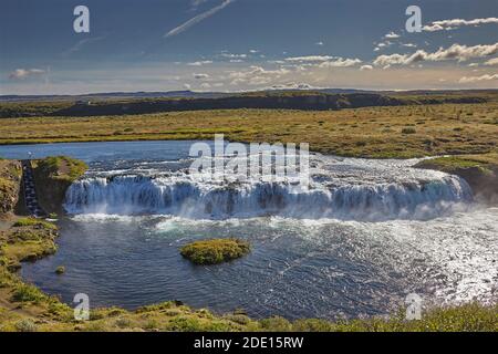 A foaming waterfall, Faxifoss Falls, near Geysir, southwest Iceland ...