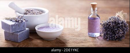 Lavender's spa products with dried lavender flowers on pink background ...