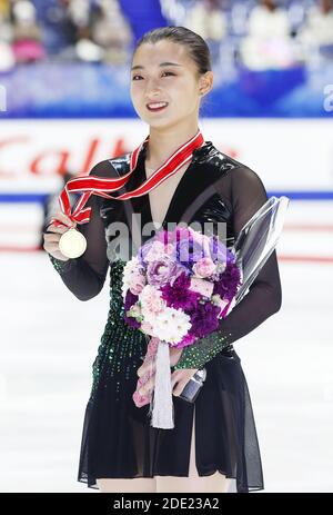 Kaori Sakamoto (C) poses after winning the women's title at the ...