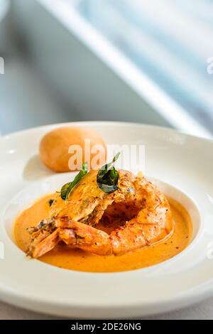 main course of King Prawn served in Bang Sauce with a bun Stock Photo ...