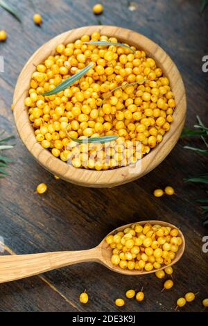 Wooden Spoon with White Bowl with Five Tomatoes Placed on Yellow Cloth ...