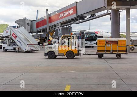 Airport luggage carrier service truck and air jetty moving on the ...