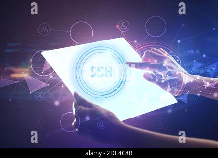 Hand holdig futuristic tablet with SSH inscription, modern technology ...
