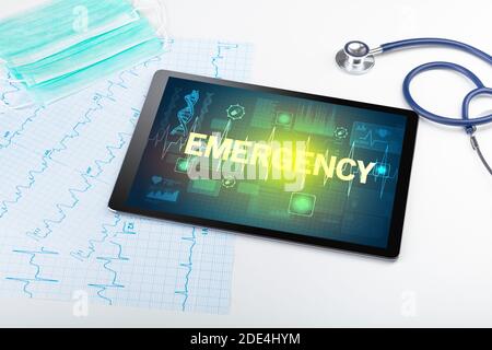 Tablet pc and medical stuff with EMERGENCY inscription, prevention ...