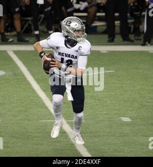 Nevada quarterback Carson Strong looks downfield under pressure from ...