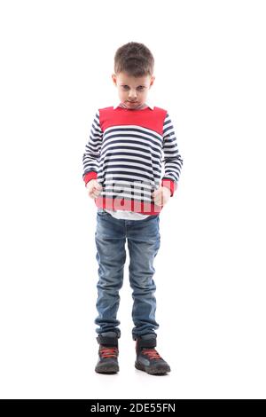 Sad disappointed little kid with bowed head looking down and ...