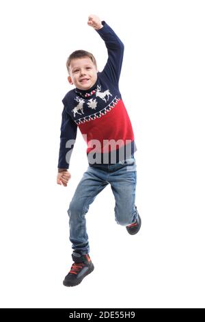 full length of excited kid with clenched fists on yellow Stock Photo ...